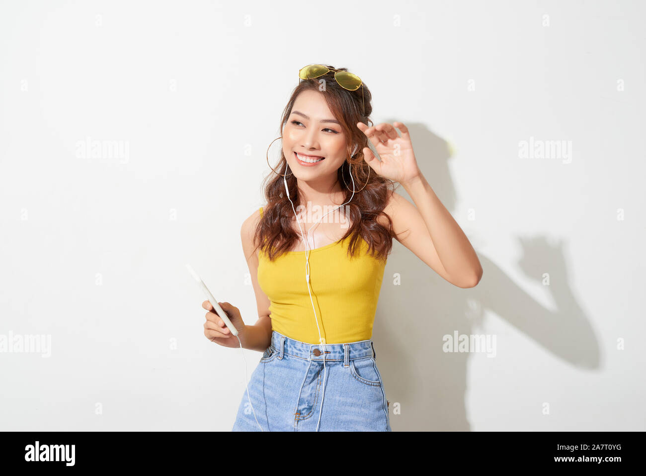 Summer lady. Beautiful asian girl singing and dancing while listening ...