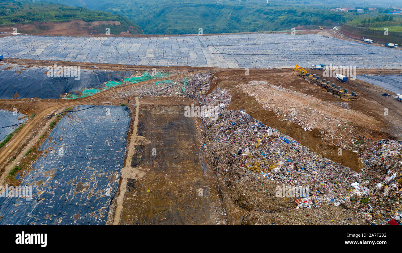 Chinese workers sort out and bury kitchen waste at the Jiangcungou ...