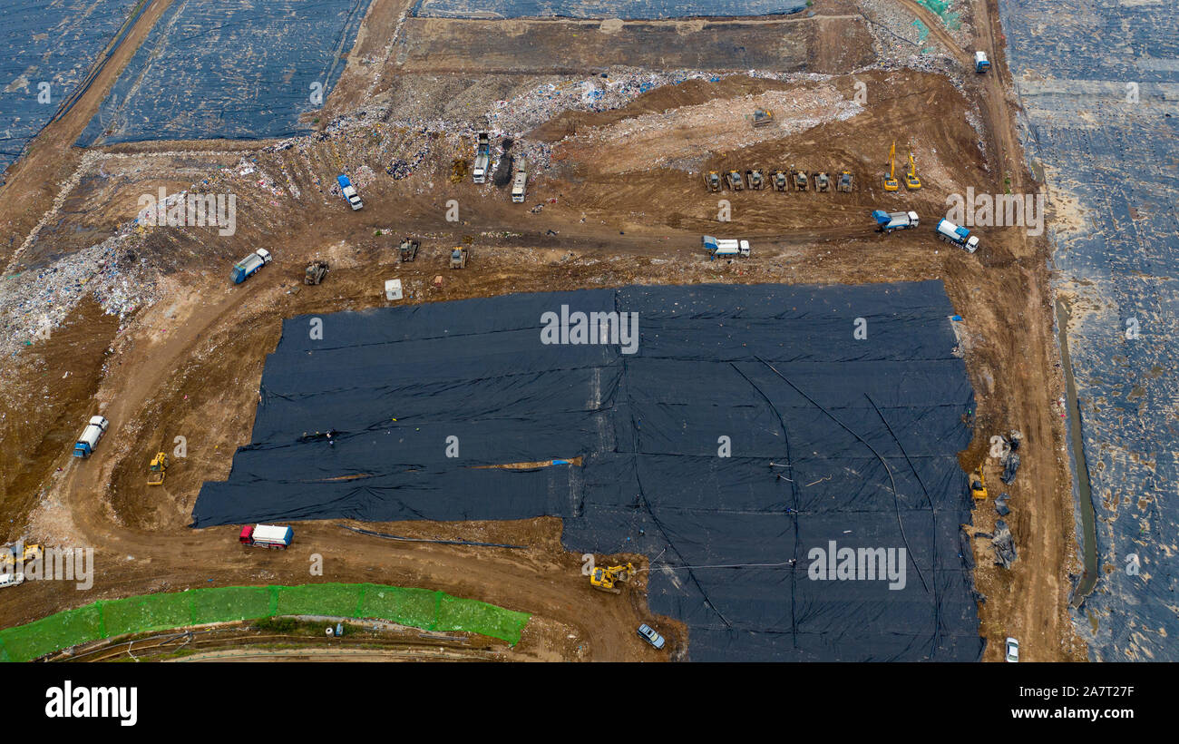 Chinese workers sort out and bury kitchen waste at the Jiangcungou ...