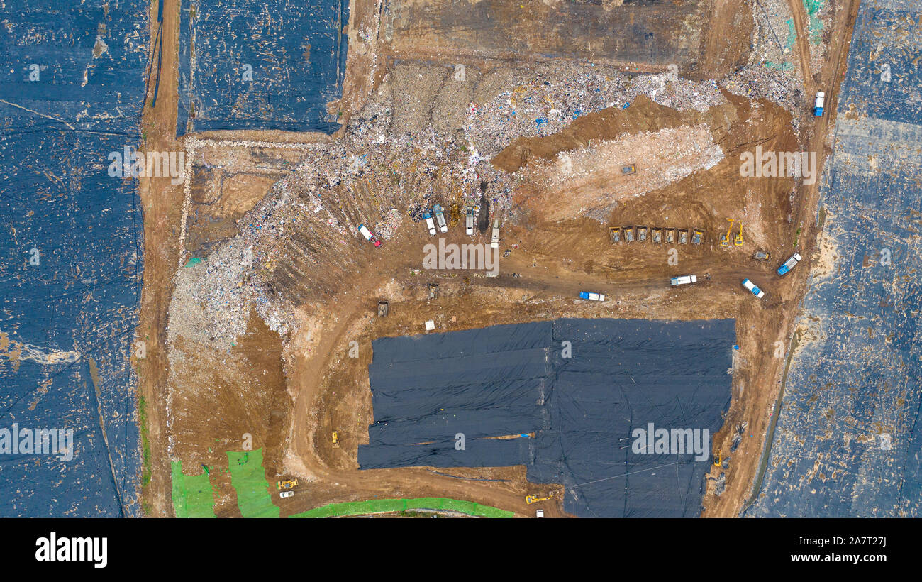 Chinese workers sort out and bury kitchen waste at the Jiangcungou ...