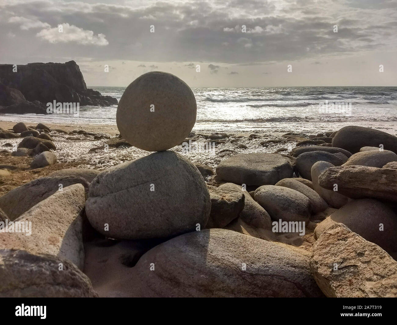 Stone balancing on stone - stone laid on other stone on seacoast Stock ...