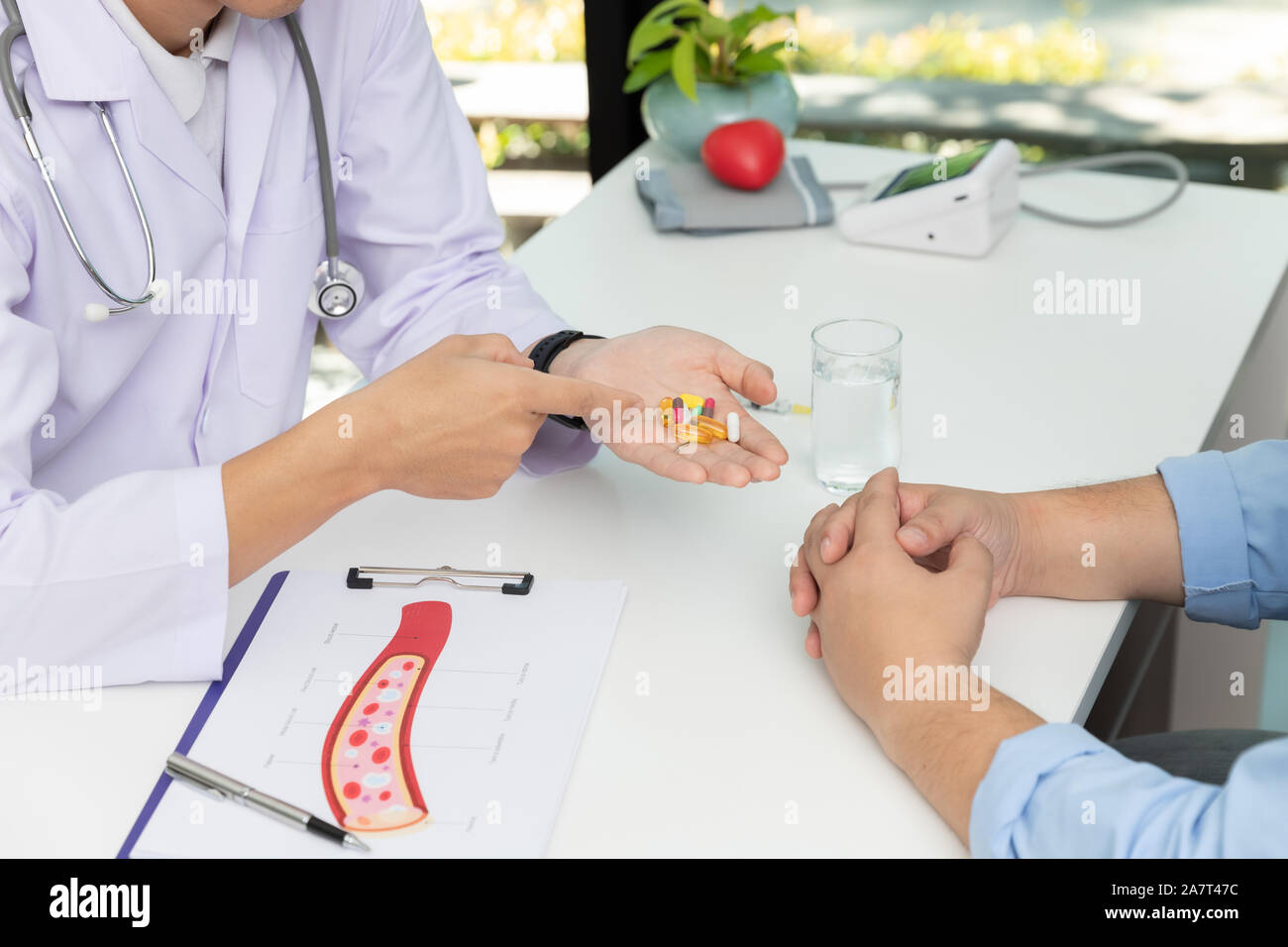 Doctor holding medicine pills in hand and explained medication to ...