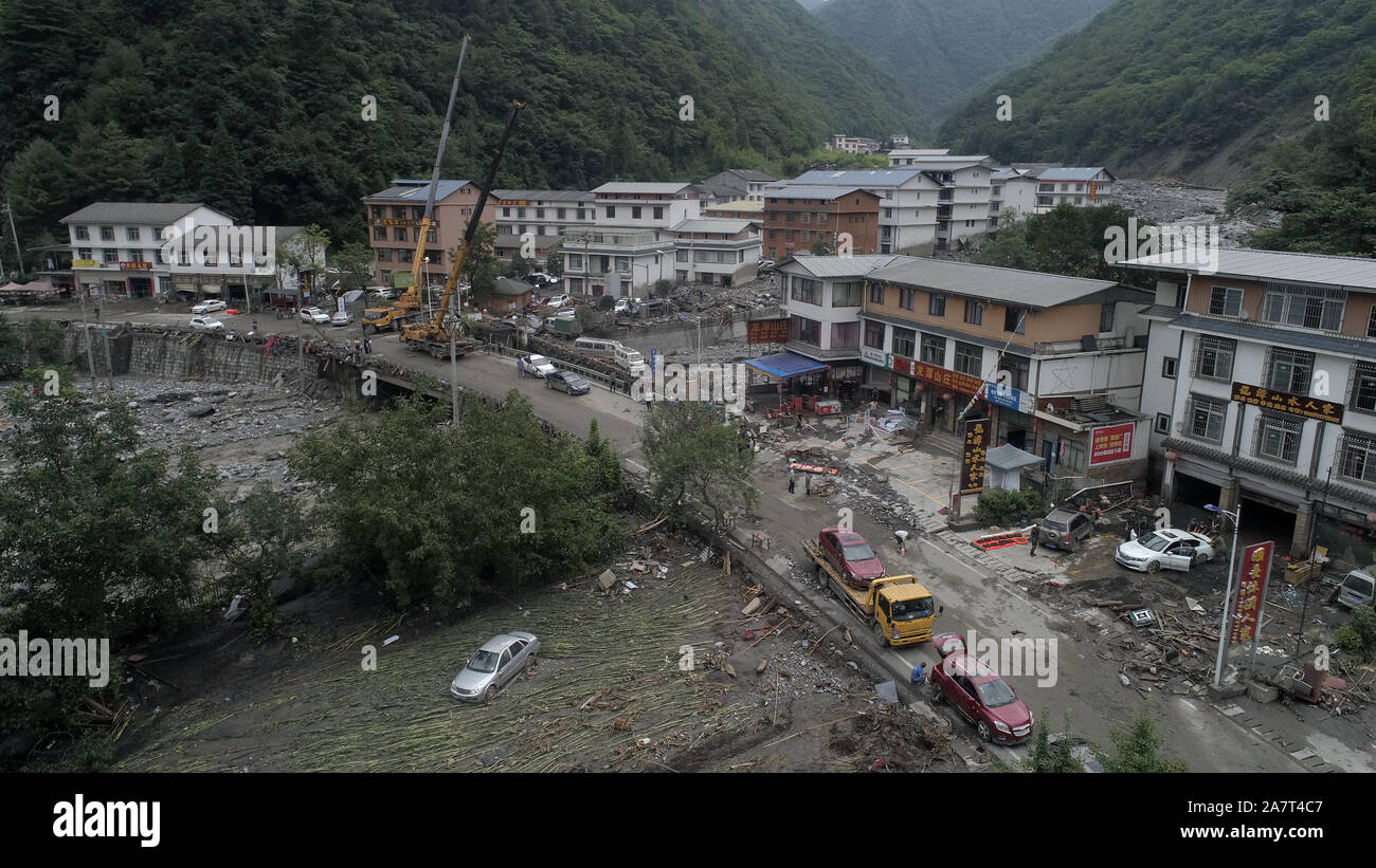 Residential buildings are covered with mud and stones after being hit ...