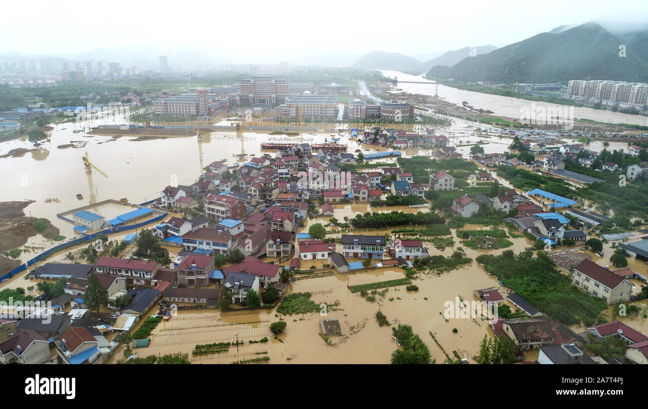 Aerial view of residential buildings and fields submerged by floodwater ...