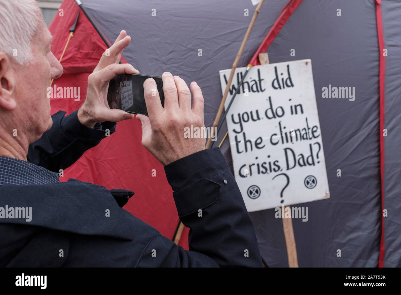 UK,London, 2019, Extinction Rebelion. man taking a photograph of ...