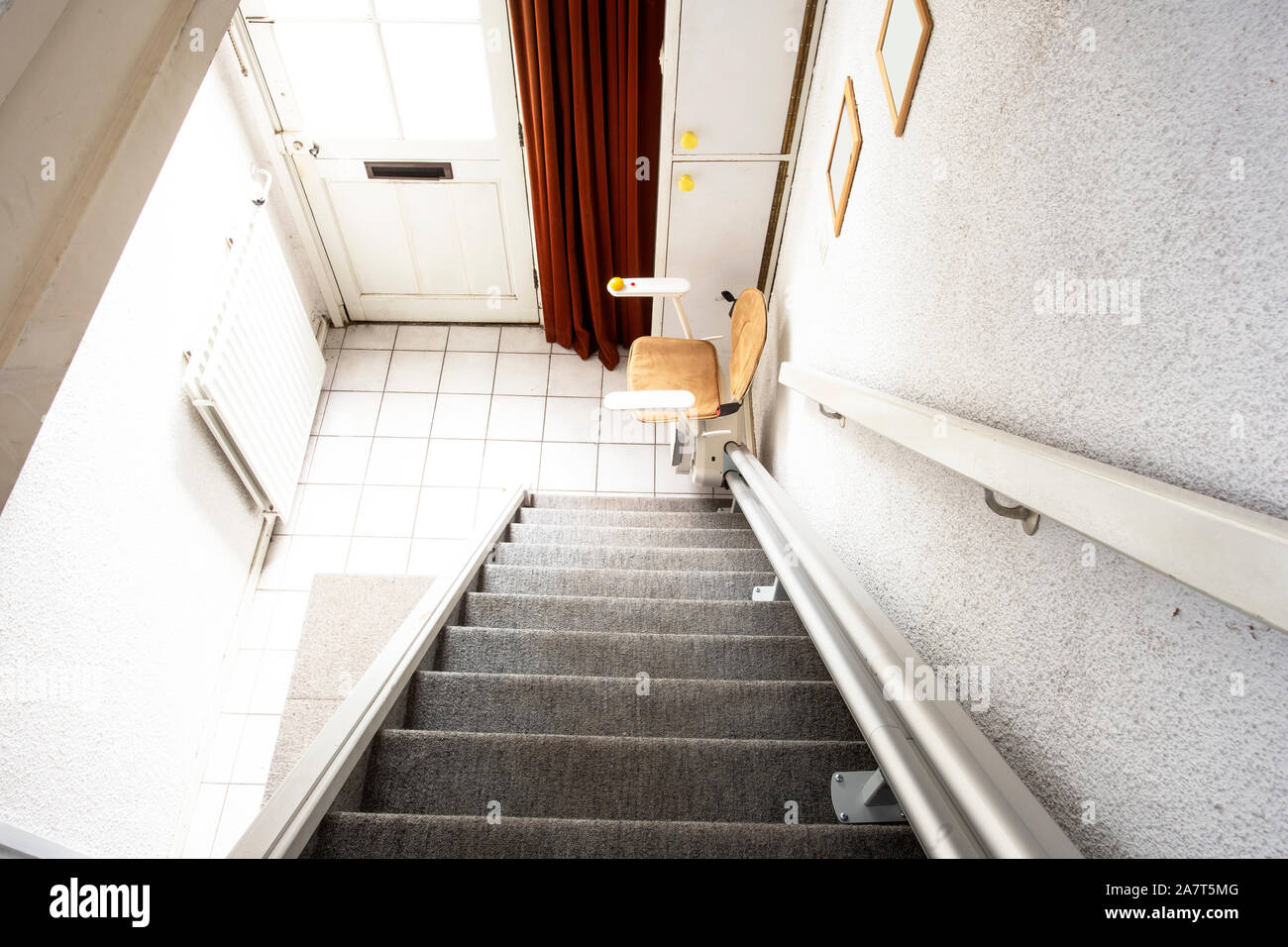 Automatic stair lift on staircase taking elderly people and disabled ...