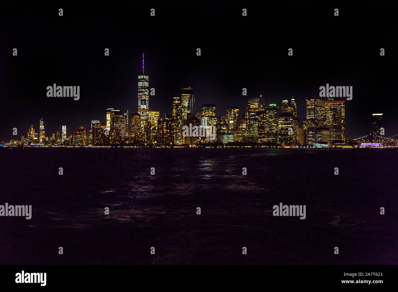 Manhattan island at night, photographed from the Staten Island Ferry ...