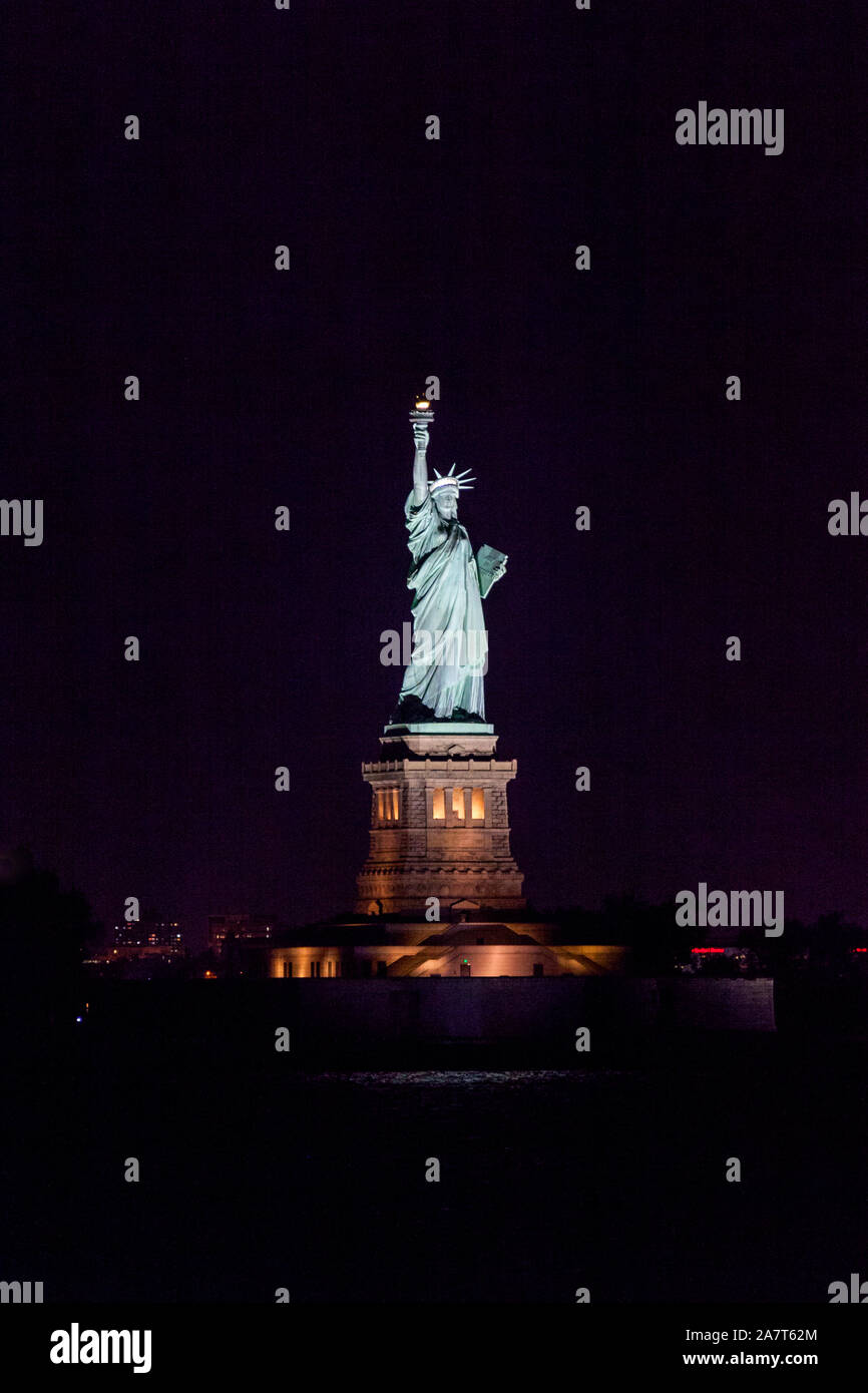 Statue of Liberty at night photographed from the Staten Island Ferry ...