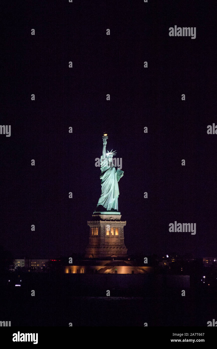 Statue of Liberty at night photographed from the Staten Island Ferry ...