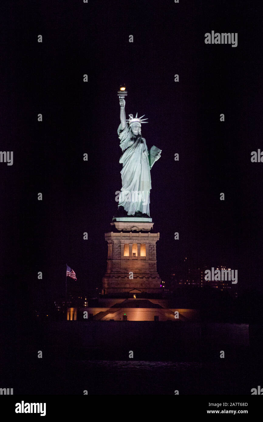 Statue of Liberty at night photographed from the Staten Island Ferry ...