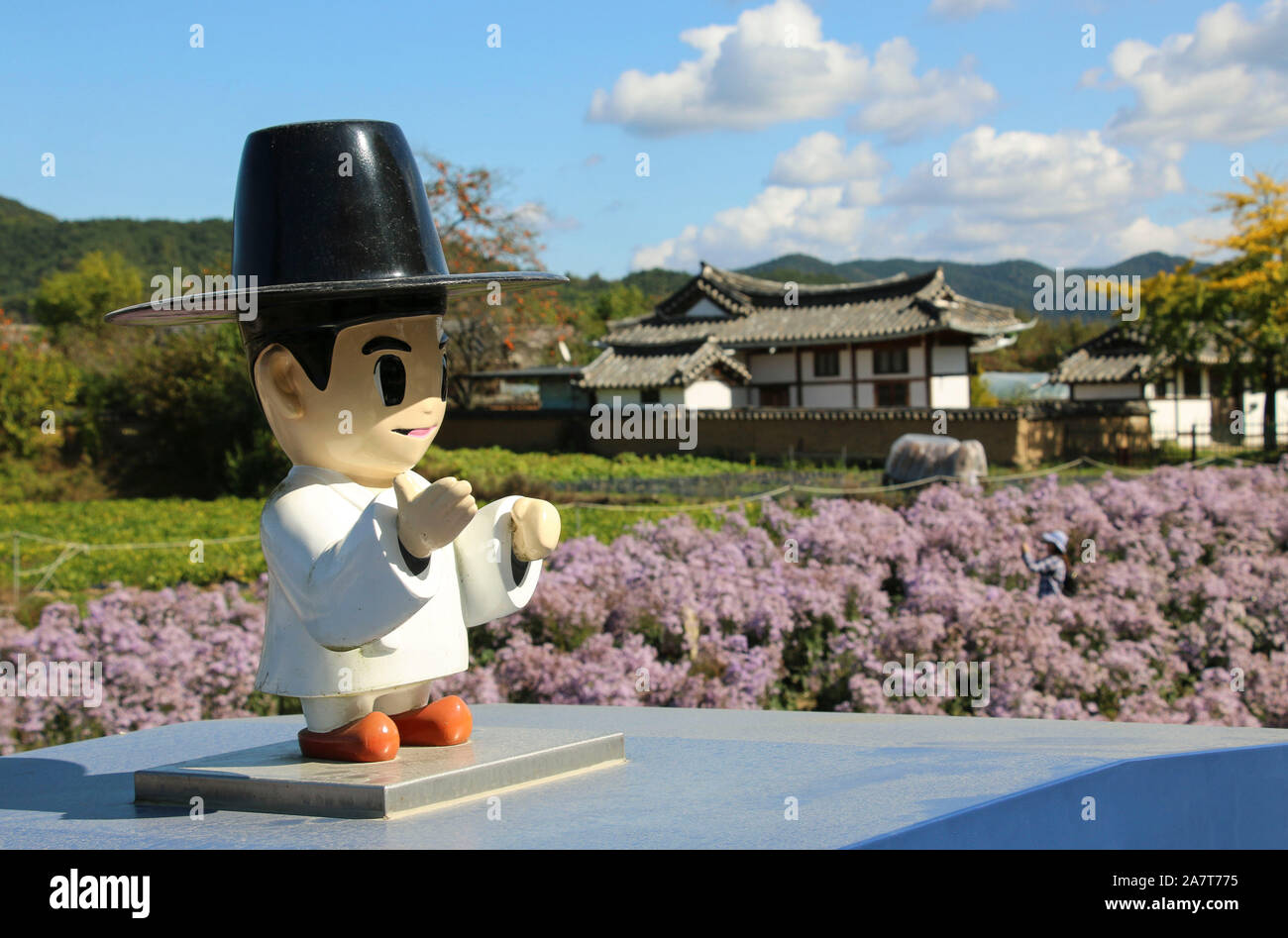 Decorative ceramic Korean figure man in traditional colorful clothes ...