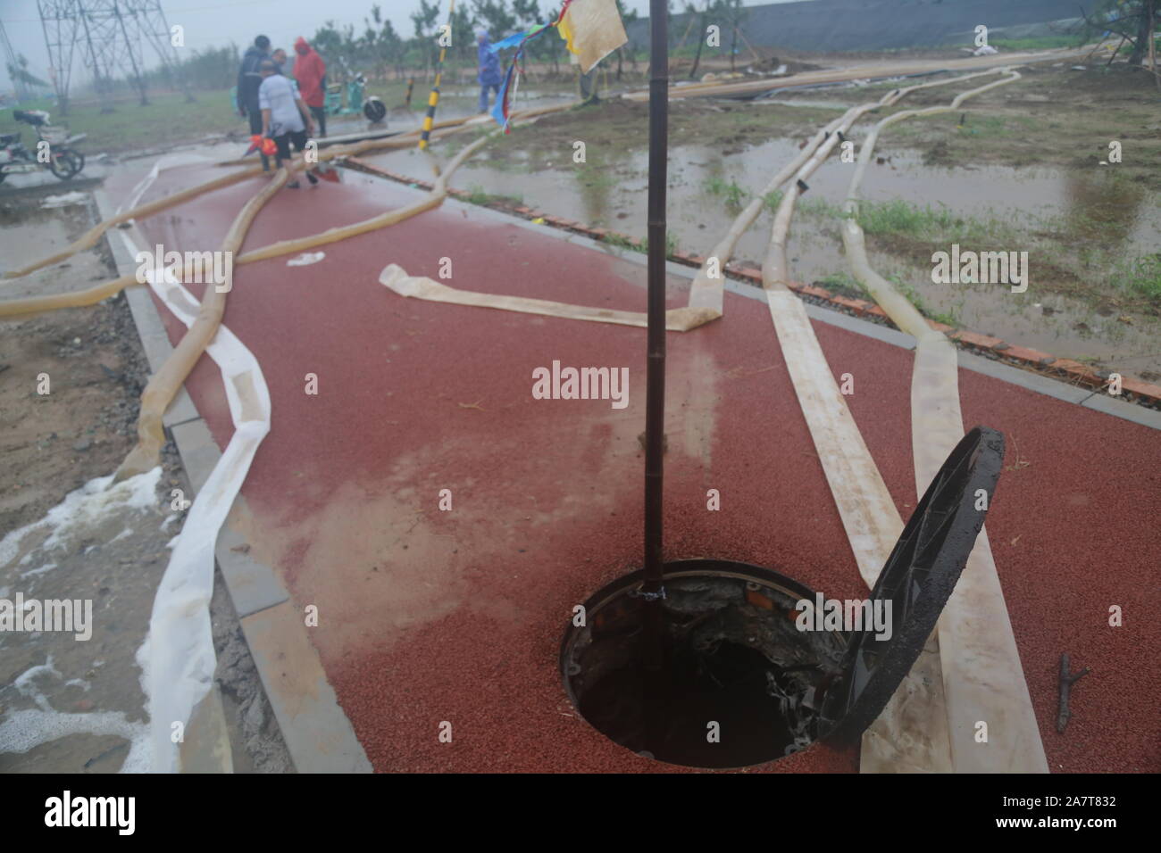 Chinese villagers pump water from the vegetable greenhouses submerged ...
