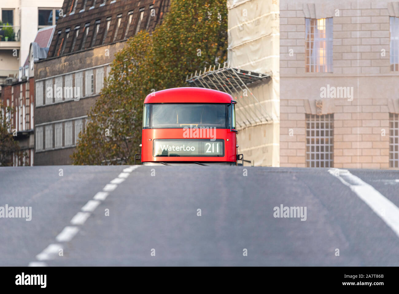 Red London bus driving over Lambeth Bridge, London, UK. Route 211 to ...
