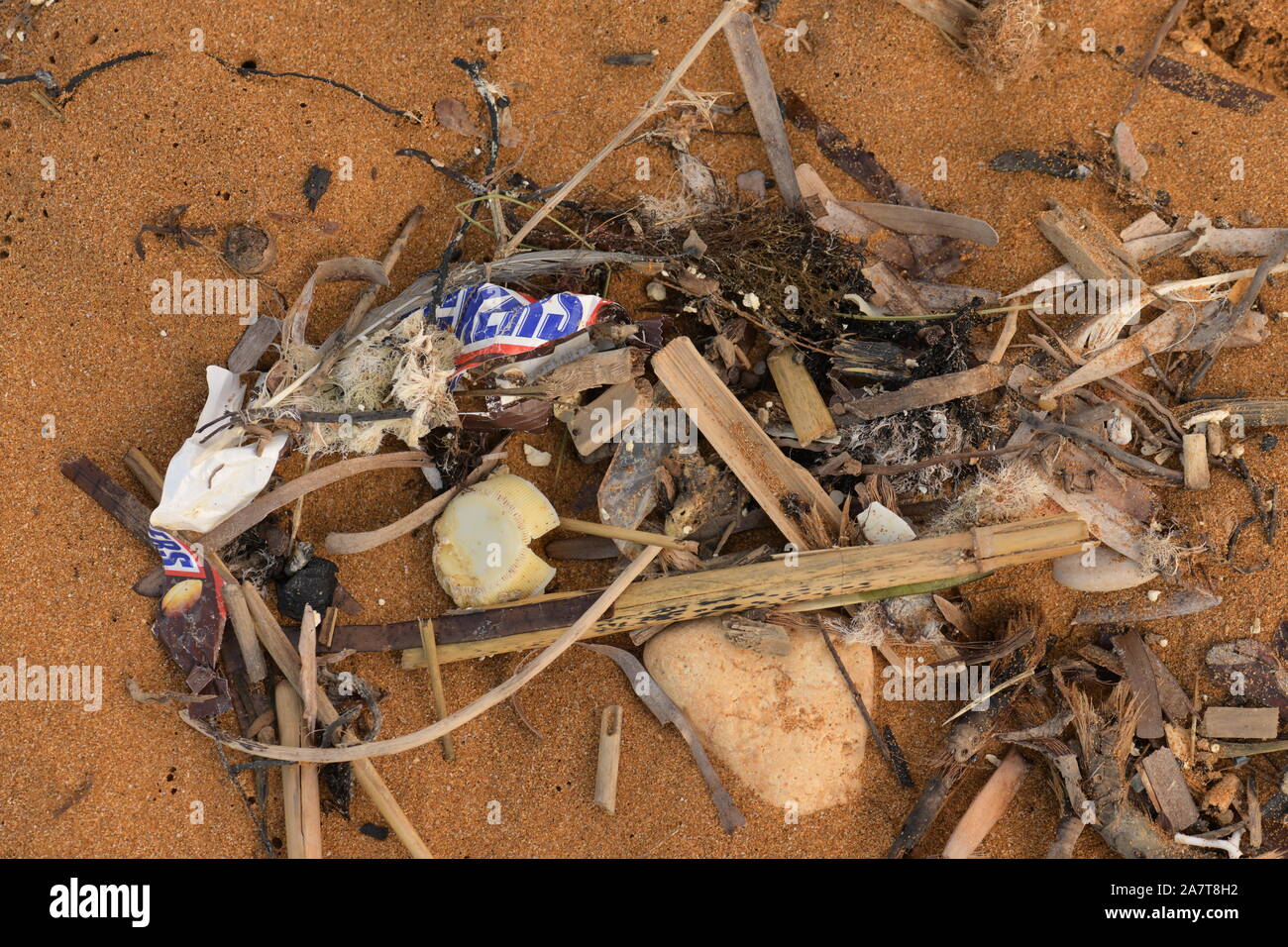 Washed up micro plastic on sand beach Stock Photo - Alamy