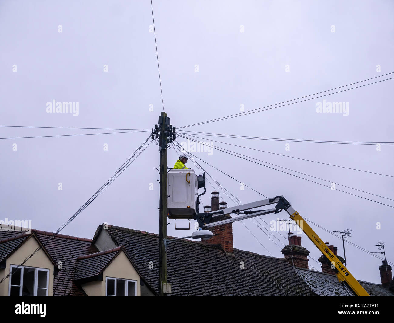 Mending telephone cables using a cherry picker Stock Photo - Alamy