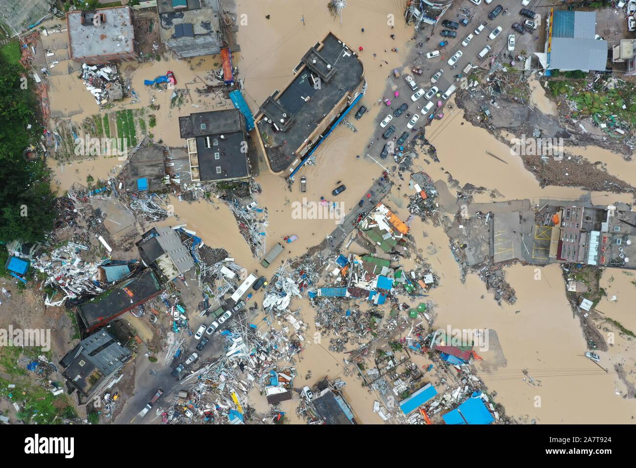 The residential buildings and fields are submerged in floodwater after ...
