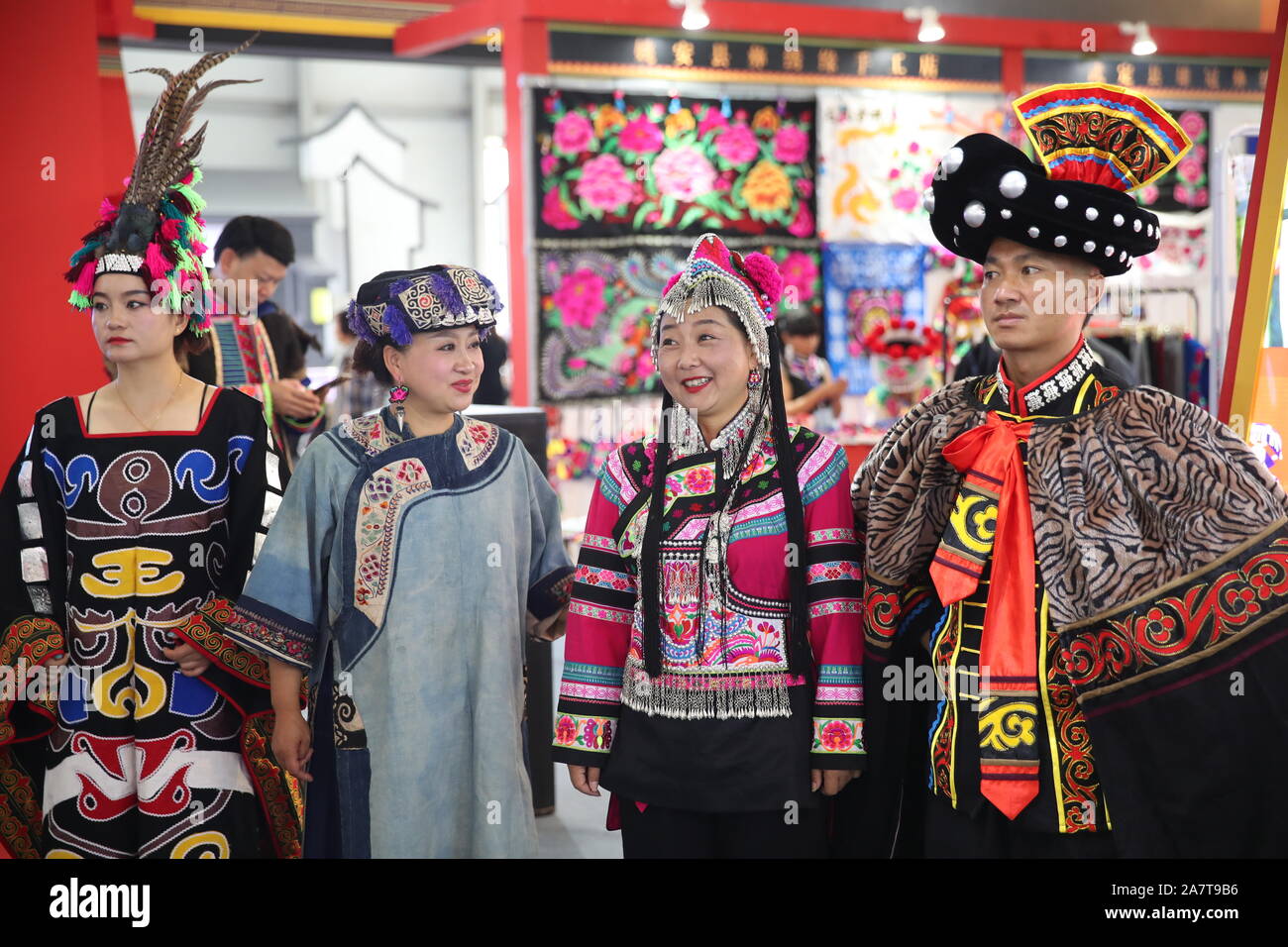 Chinese ethnic people dressed in traditional costumes perform during ...