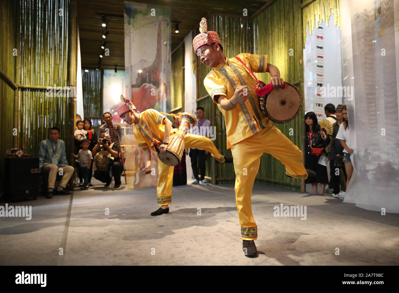 Chinese ethnic people dressed in traditional costumes perform during ...