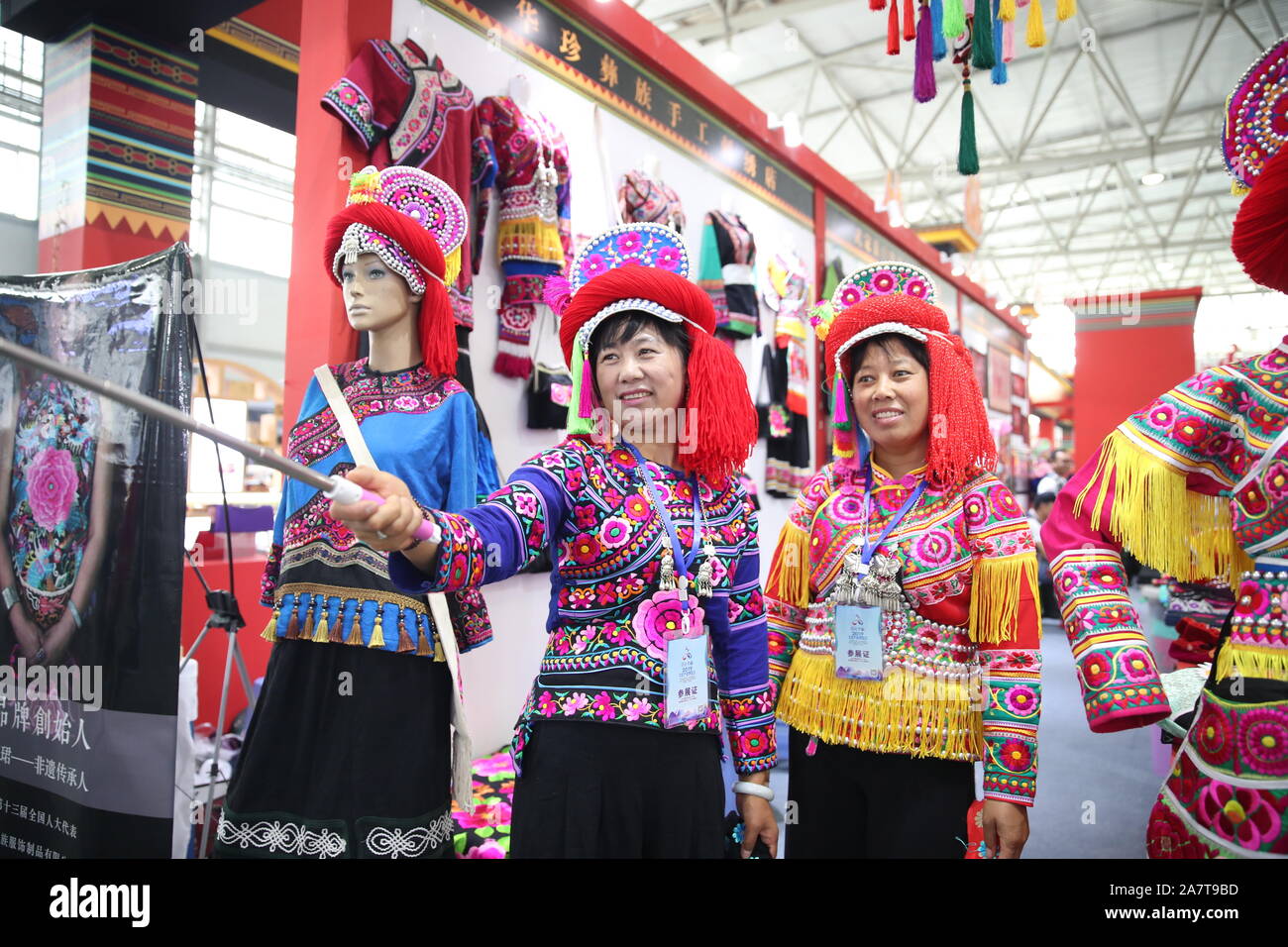 Chinese ethnic people dressed in traditional costumes perform during ...
