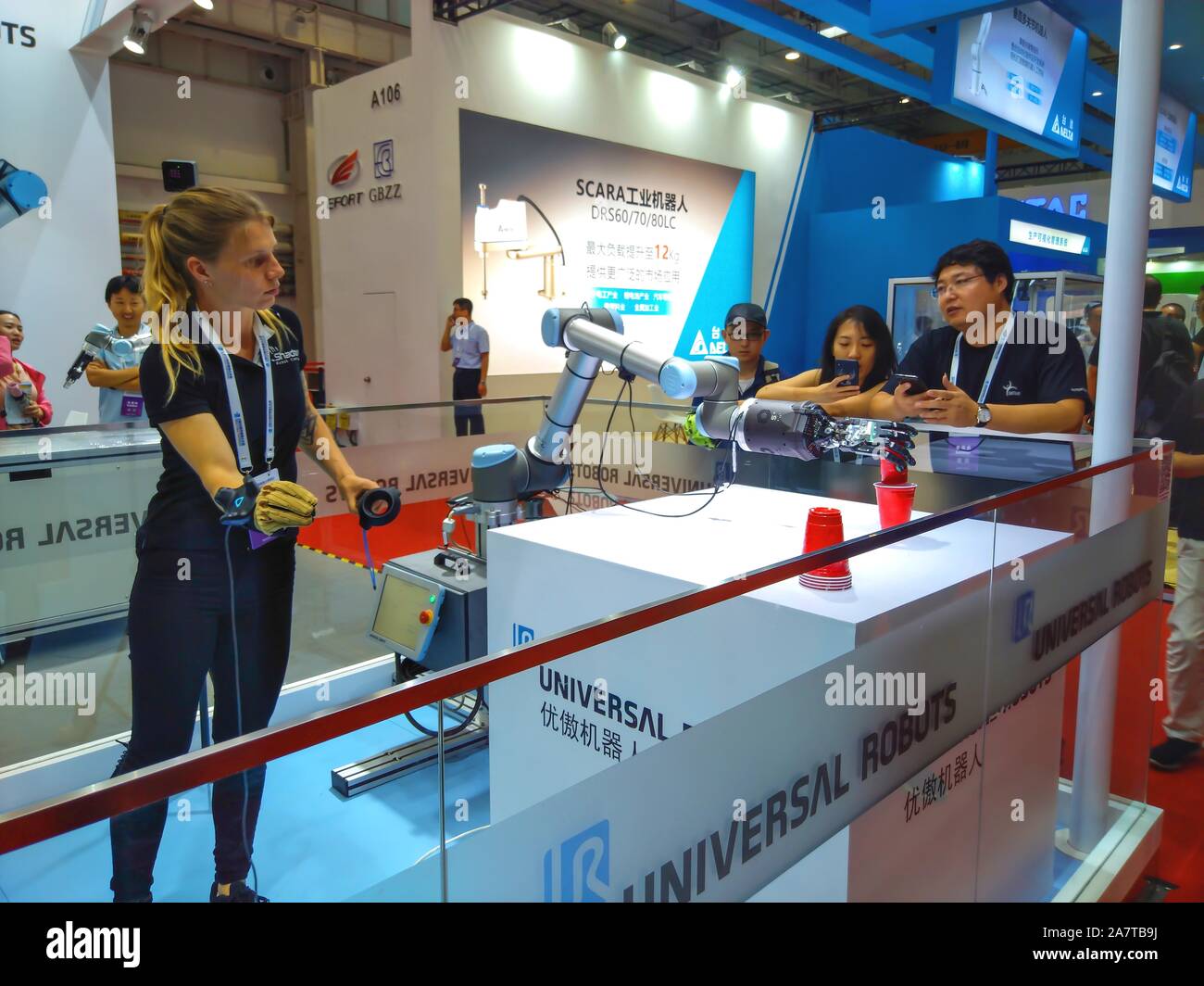 A staff demonstrates the operation of a robot hand at the 2019 World ...