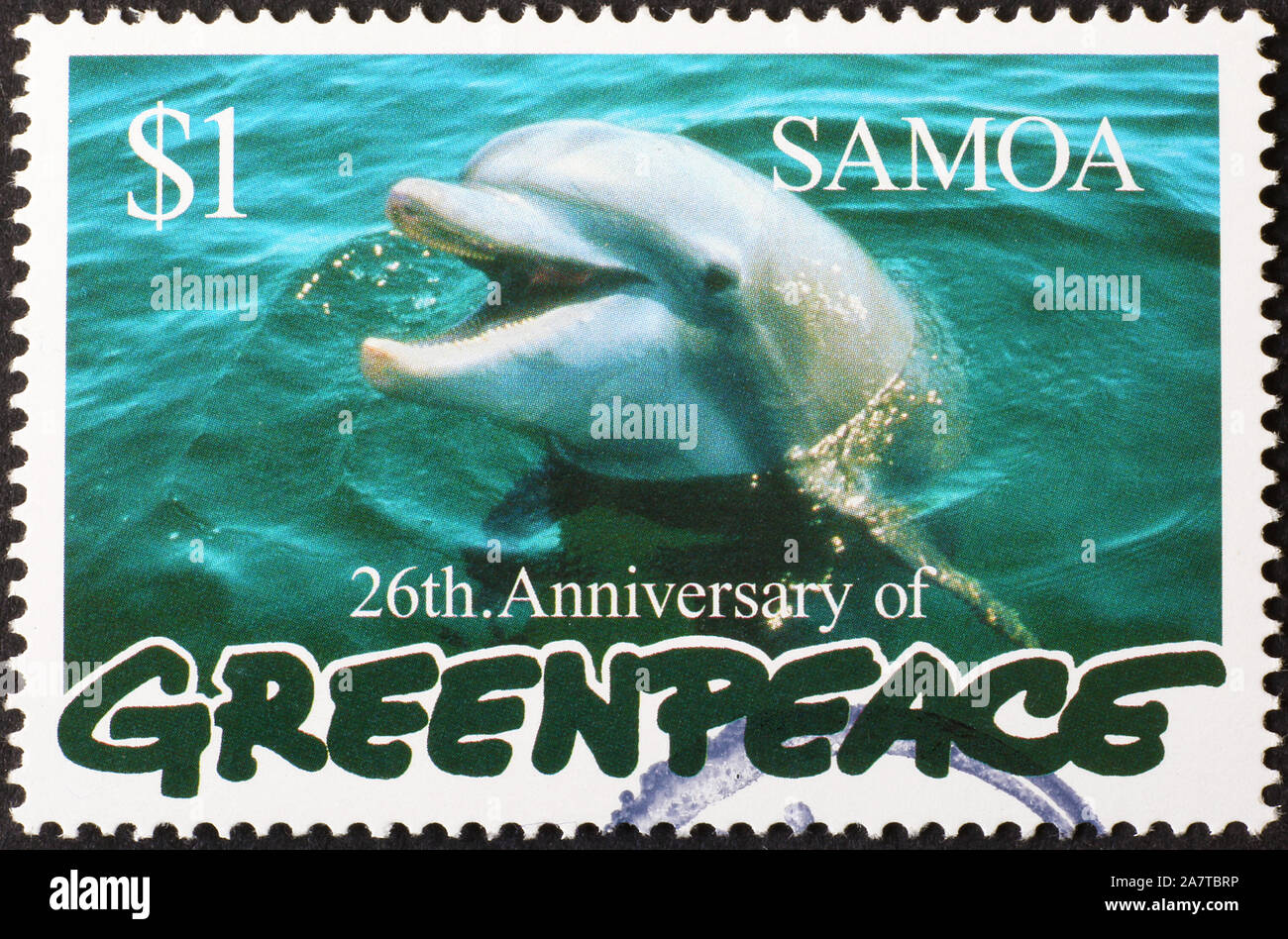 Dolphin looking at you on Greenpeace postage stamp Stock Photo - Alamy