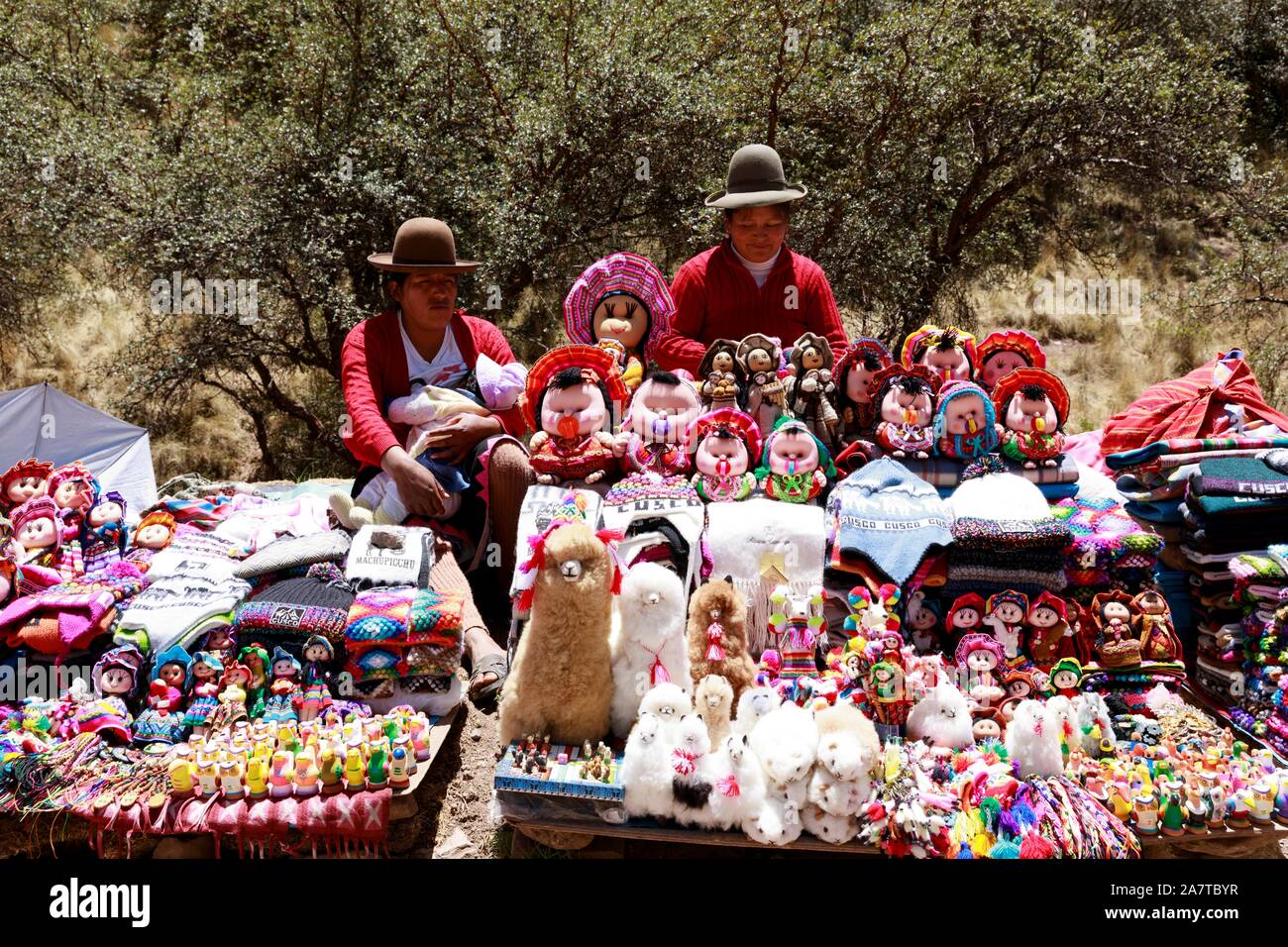 Peruvian woman selling local textiles and fabrics made from alpaca ald ...