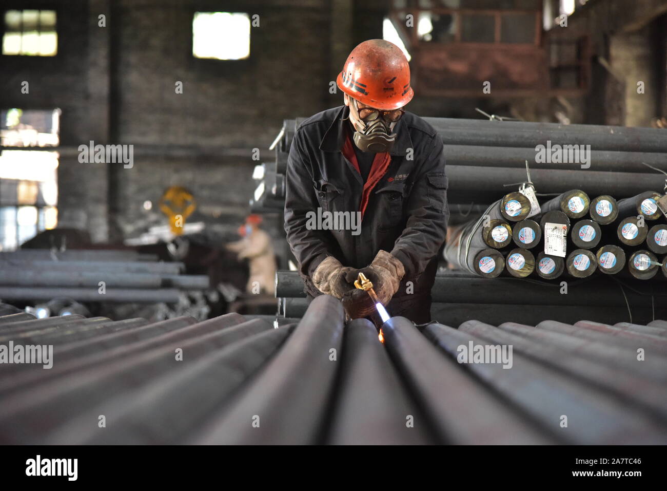 --FILE--A Chinese worker processes steel parts at the plant of Shandong ...