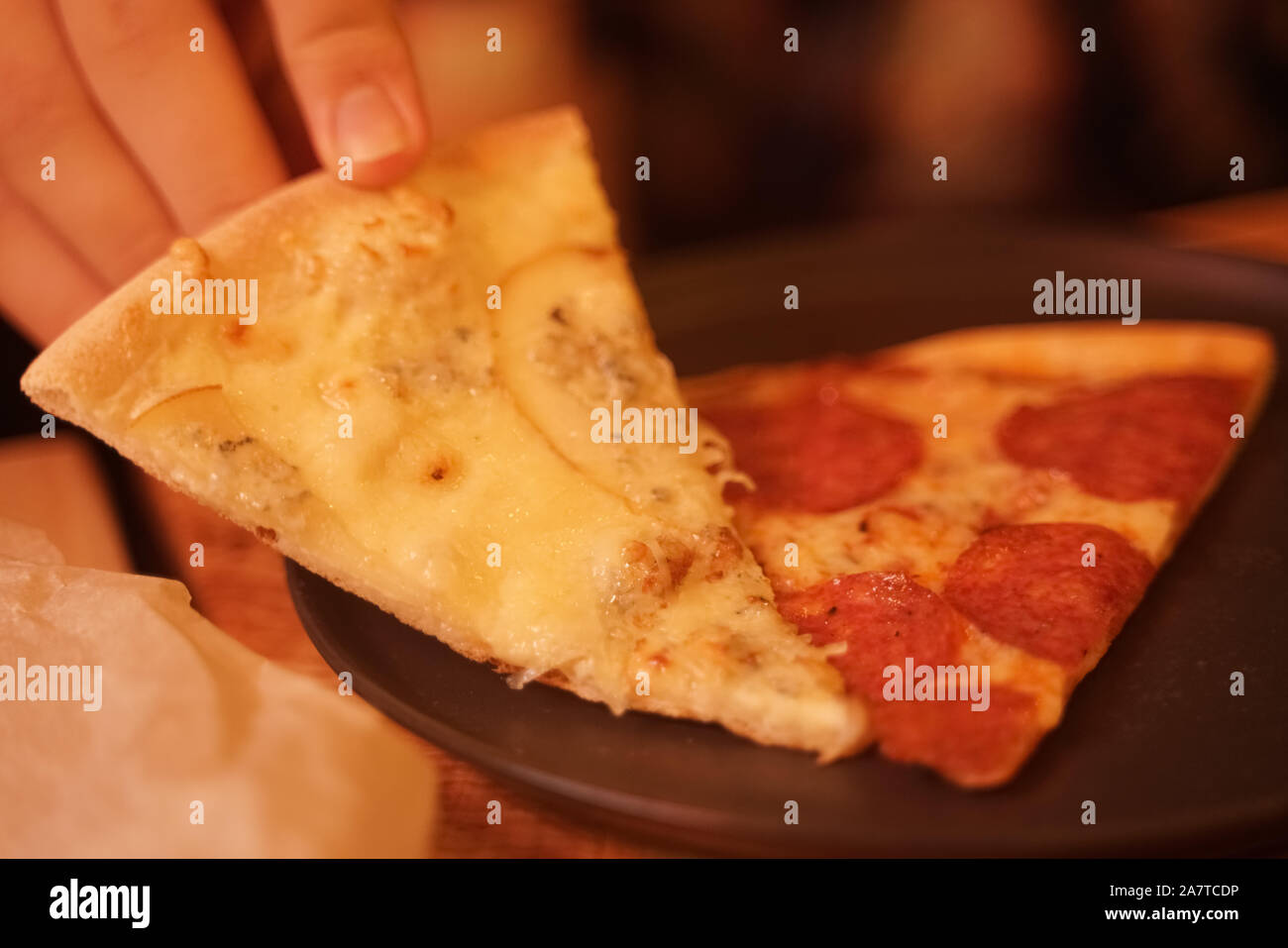 Hands two people take pizza hi-res stock photography and images - Alamy