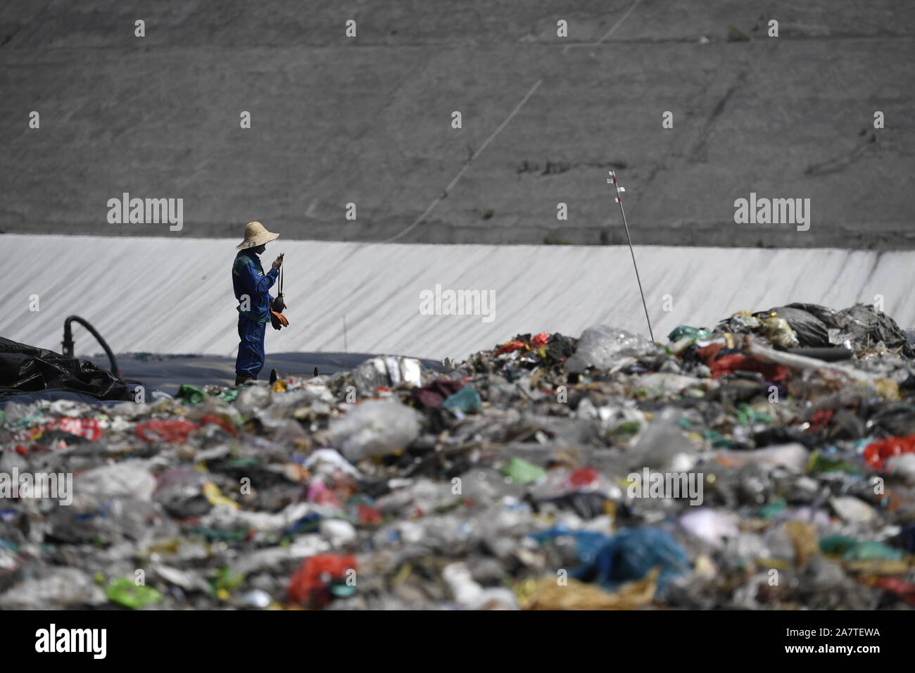 Chinese workers sort out and bury kitchen waste at the Tianziling ...