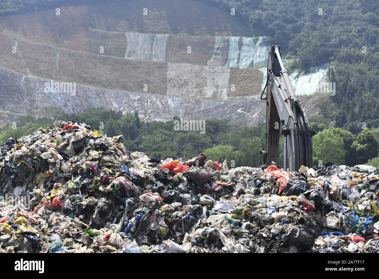 Chinese workers sort out and bury kitchen waste at the Tianziling ...