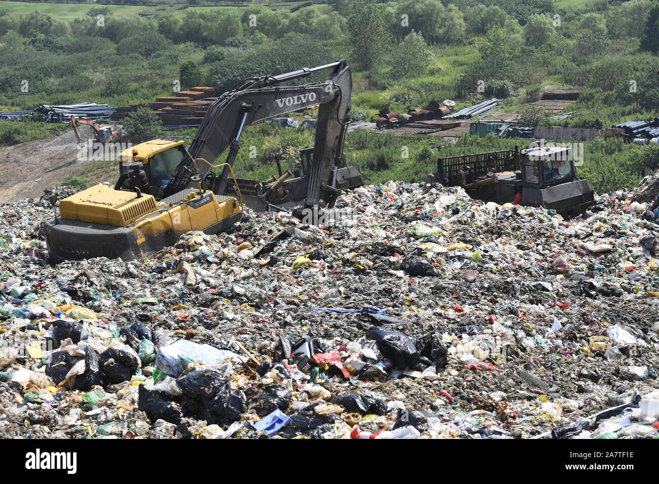 Chinese workers sort out and bury kitchen waste at the Tianziling ...