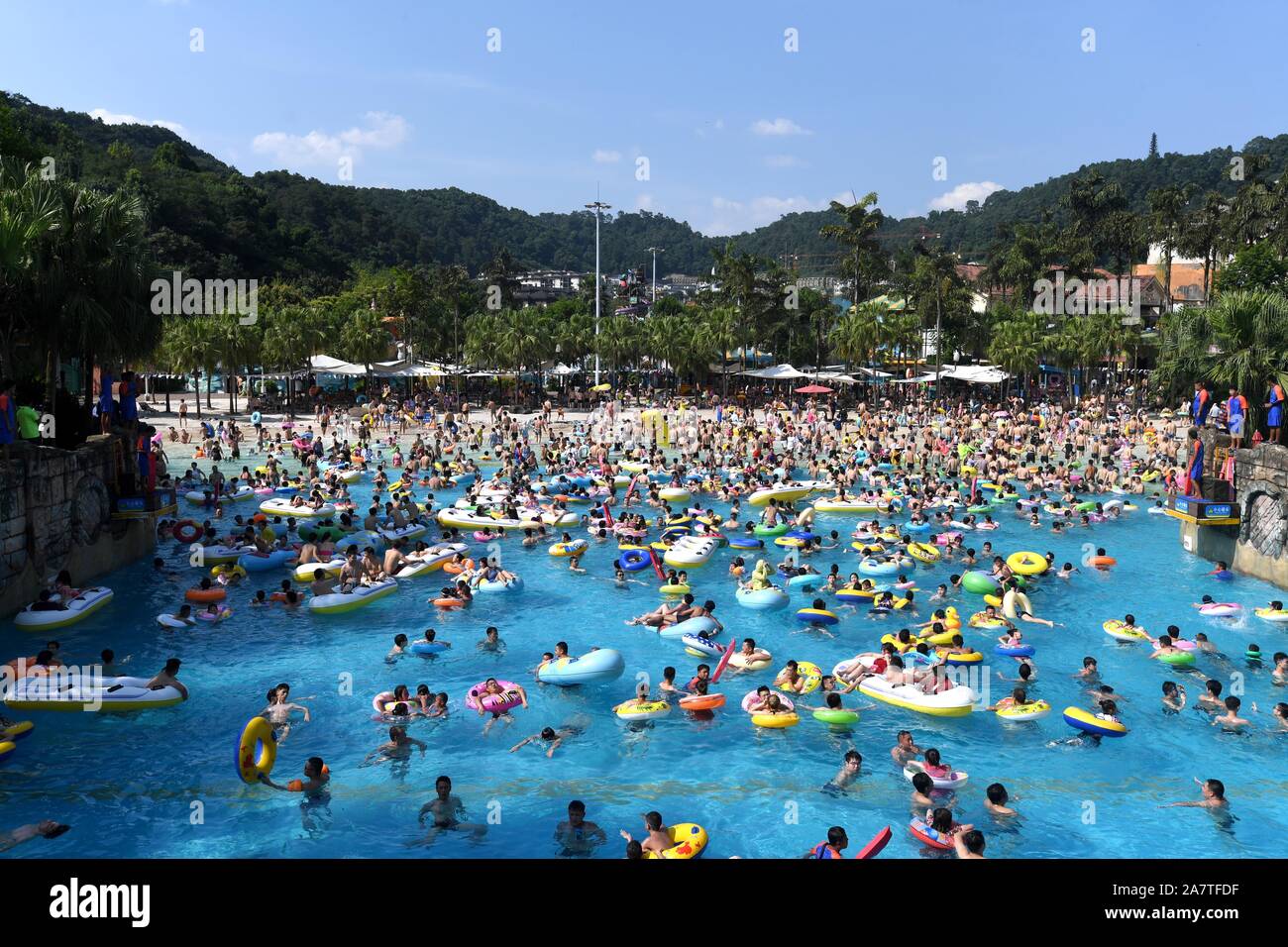 Chinese holidaymakers crowd a swimming pool at a water park to escape ...
