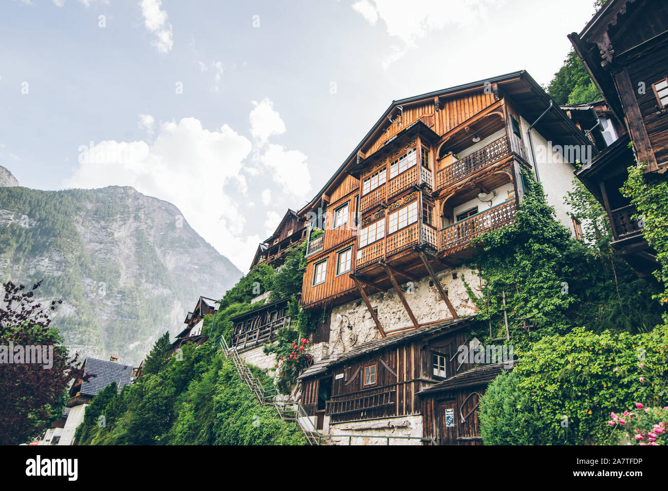 building at the cliff edge summer time hallstatt austria Stock Photo ...