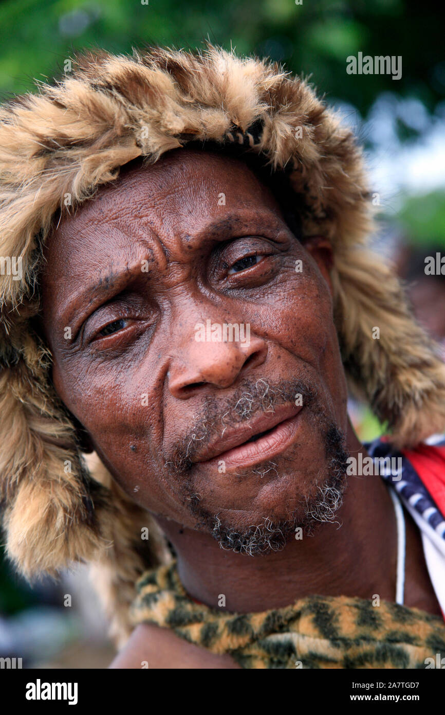 Portrait of a Zulu man in traditional headdress made of animal skin at ...