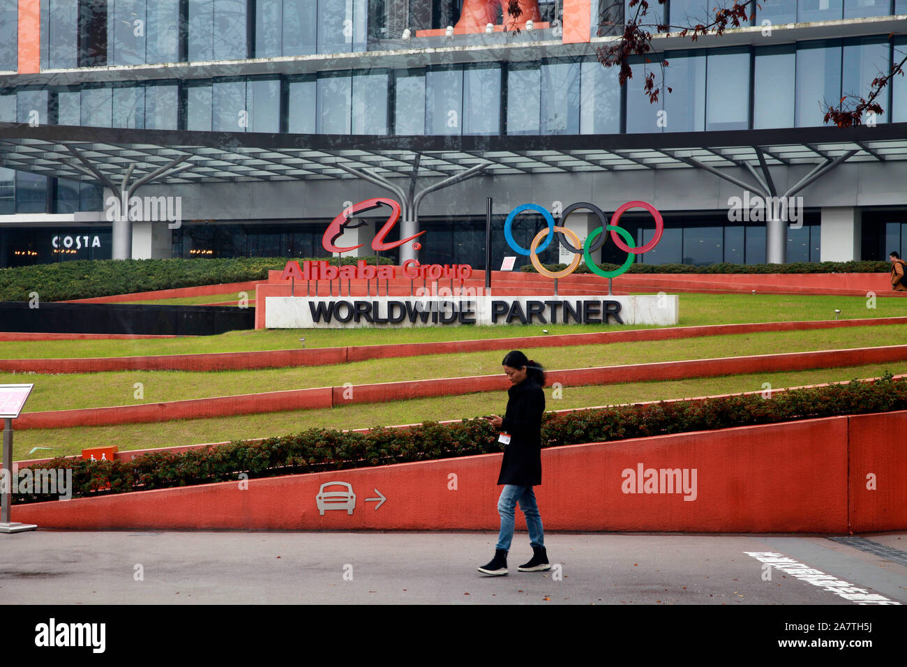 --FILE--An employee walks towards an office building of Alibaba Group ...