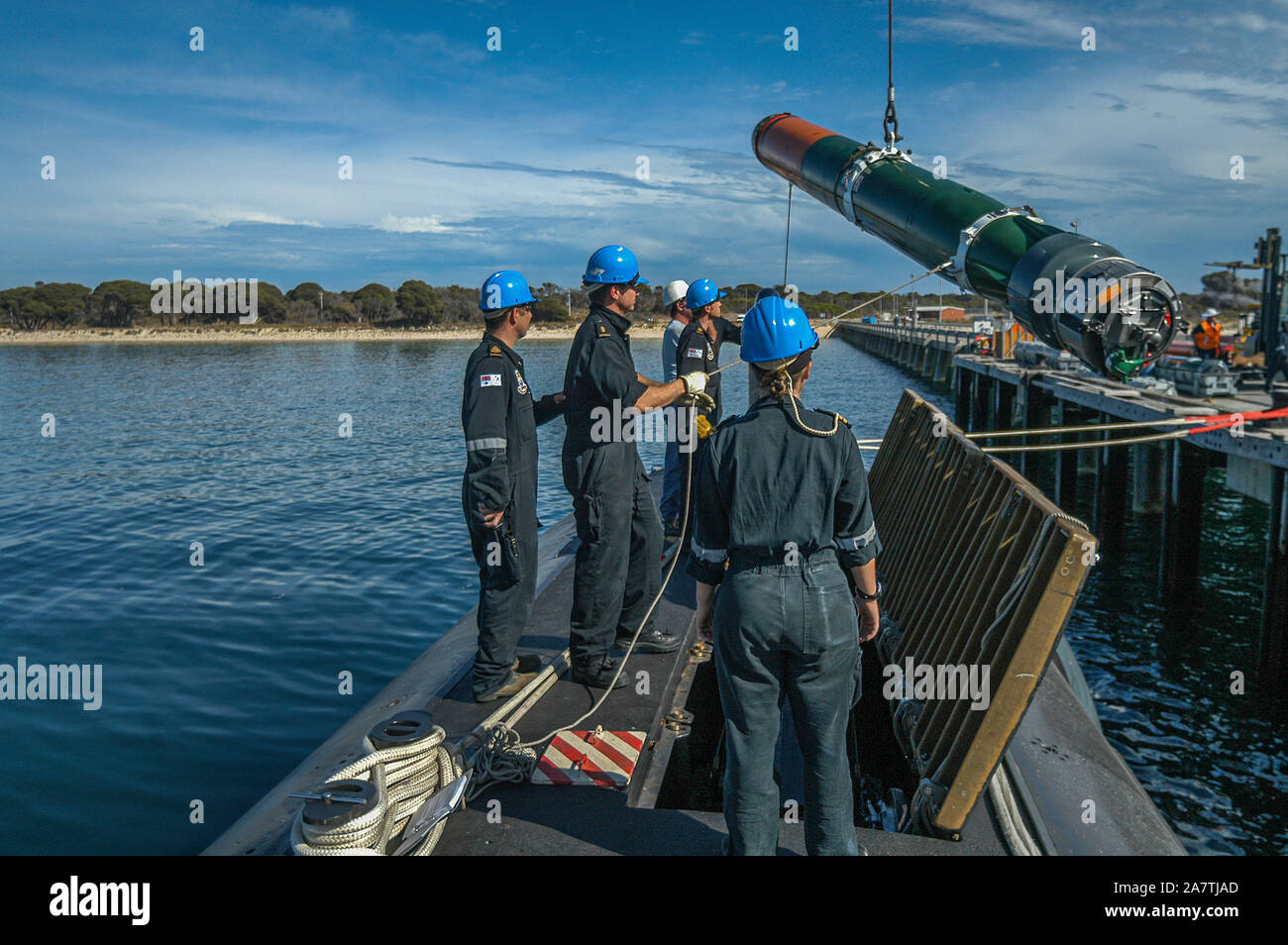 Crew loading a Mk28 torpedo from an armament wharf, to an Australian ...