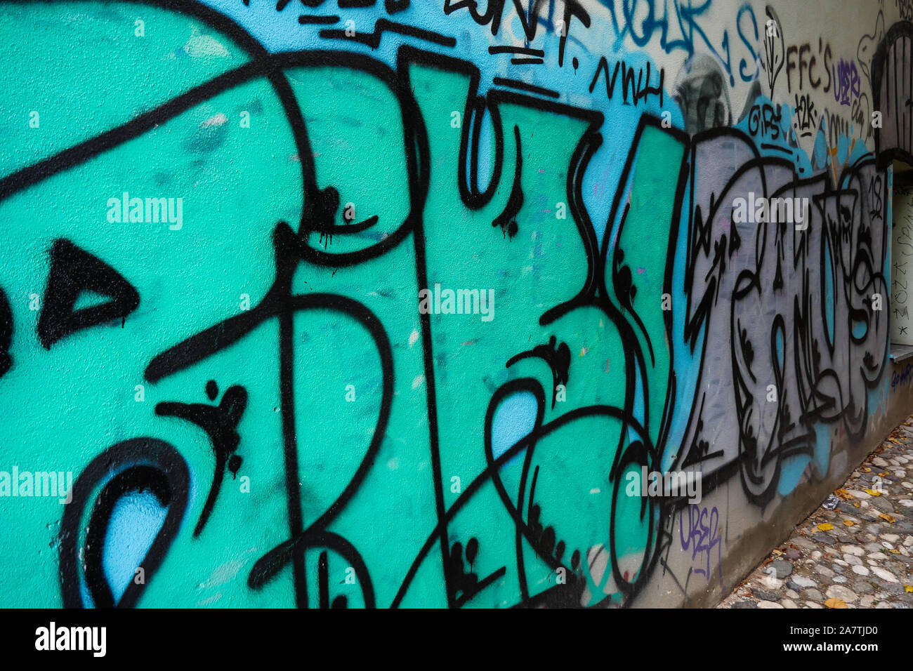 Narrow pedestrian street, with wallpaintings and graffitis, Ljubljana ...