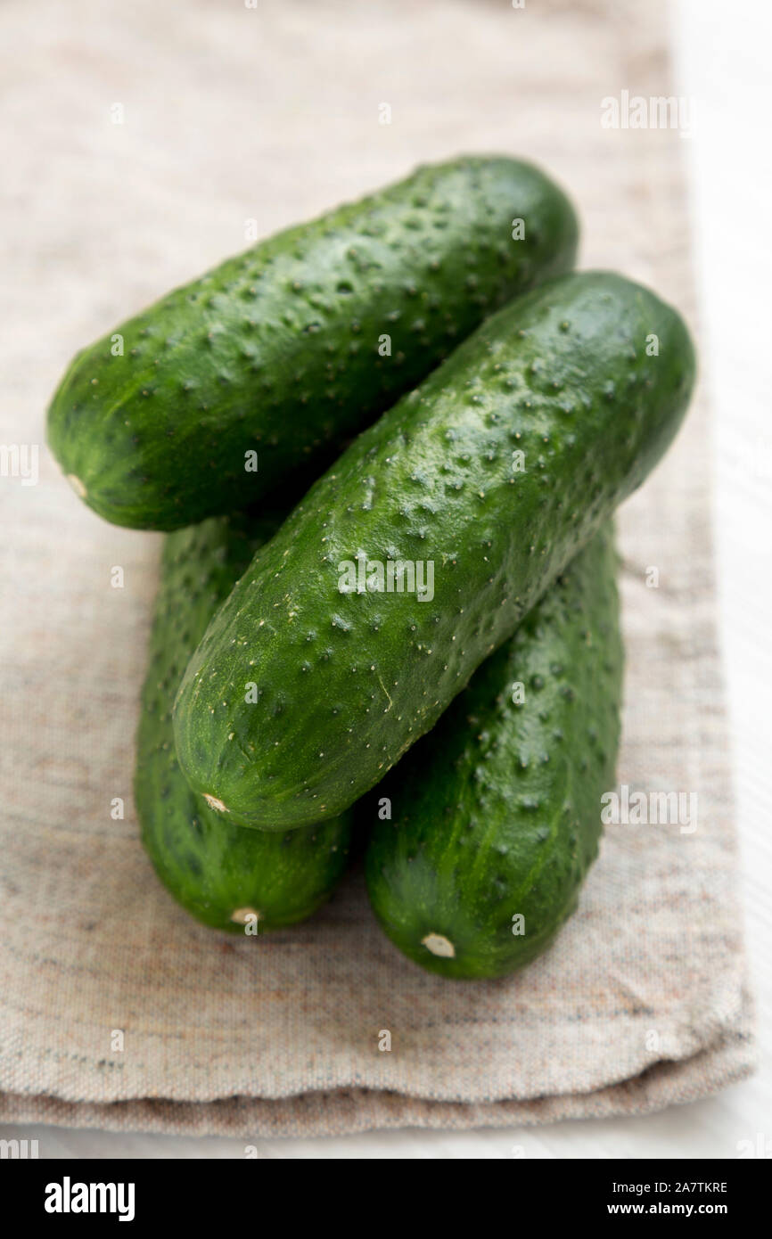 Fresh mini baby cucumbers on a rustic wooden board, low angle view ...