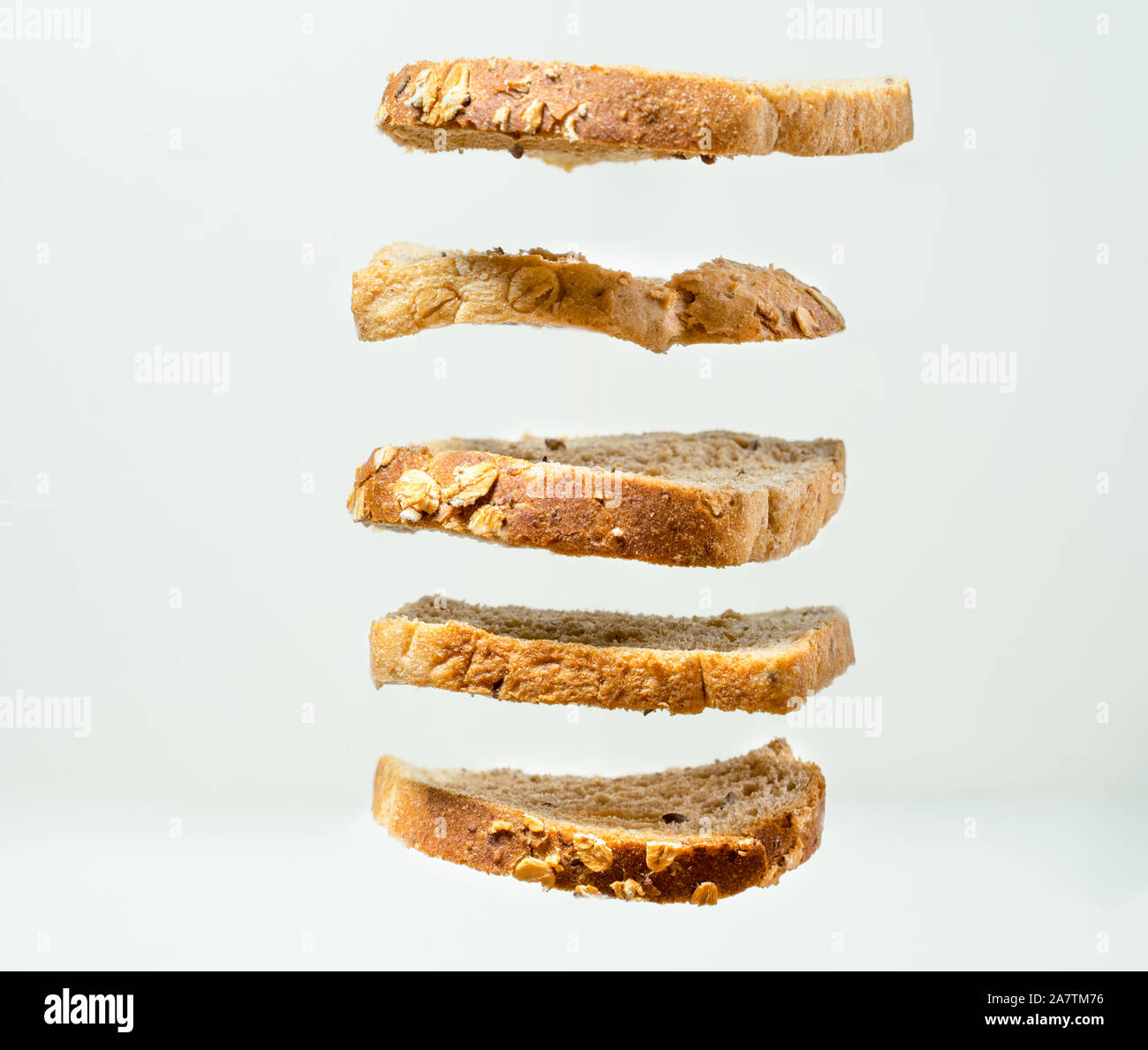Close up of floating slice of toast isolated with white background ...
