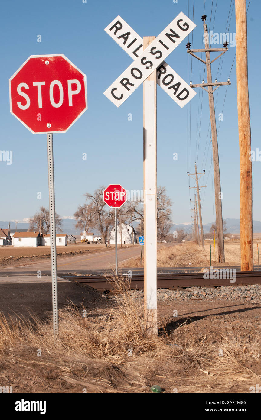 Dirt road with a railroad crossing controled with stop signs Stock ...