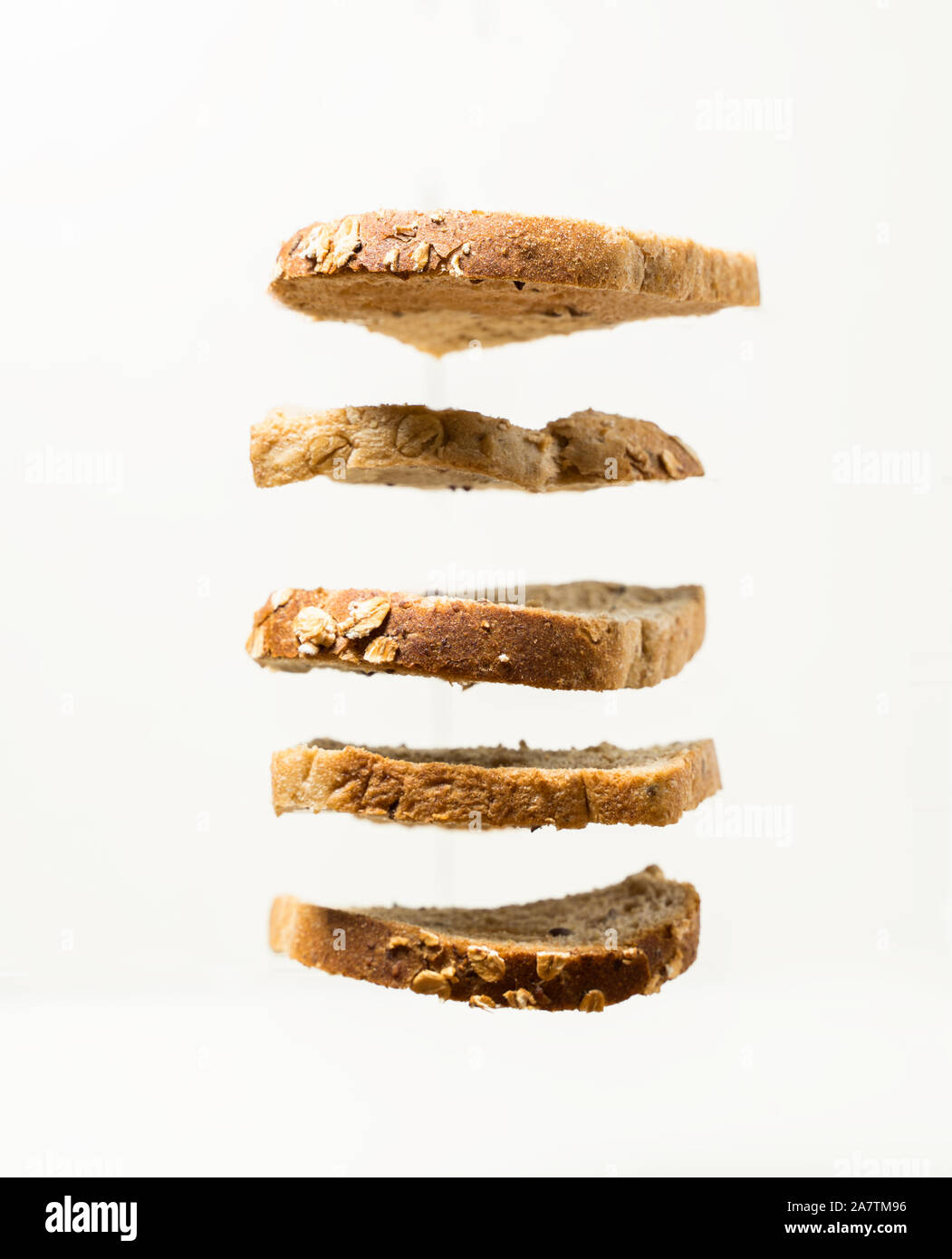 Close up of floating slice of toast isolated with white background ...