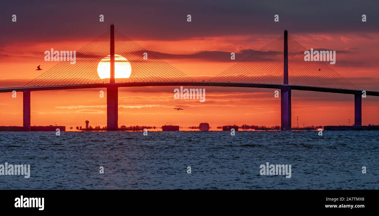Bridge with the sun rising behind it Stock Photo - Alamy