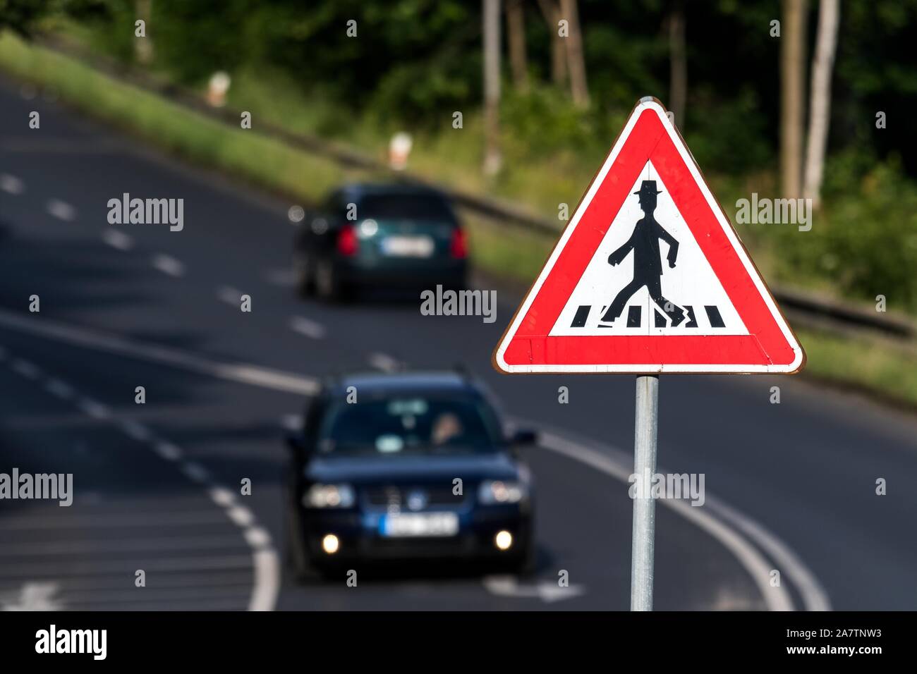 Pedestrian crossing, traffic sign and cars on road Stock Photo - Alamy