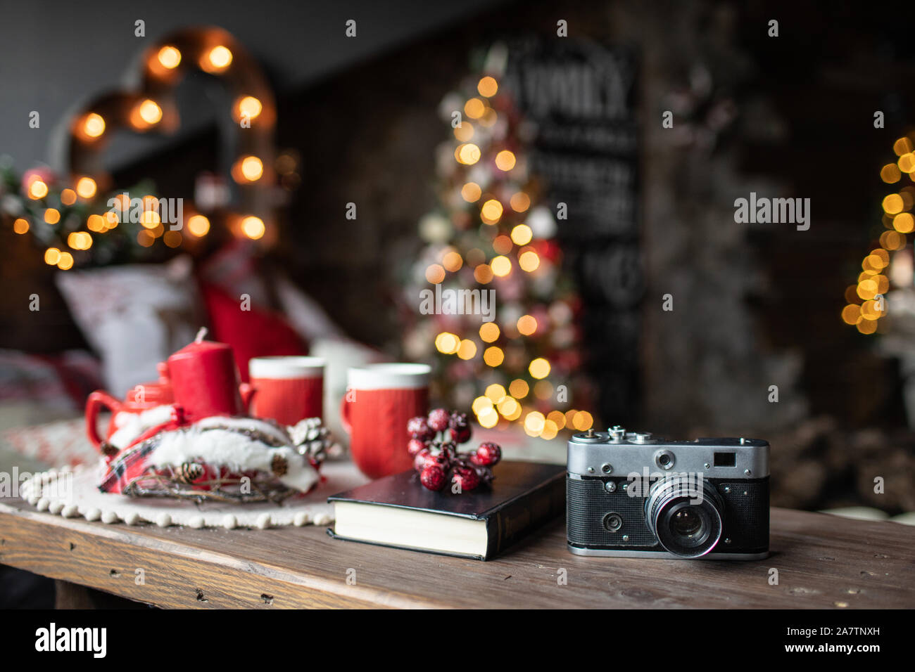 Retro camera is on the table on the background of Christmas songs and ...