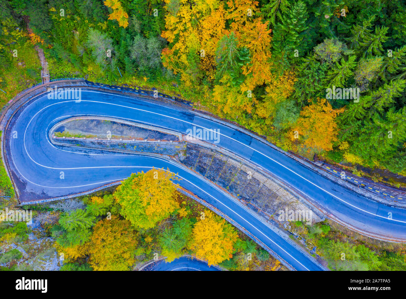 Road curve viewed from above in autumn mountain forest. Bicaz Gorges ...