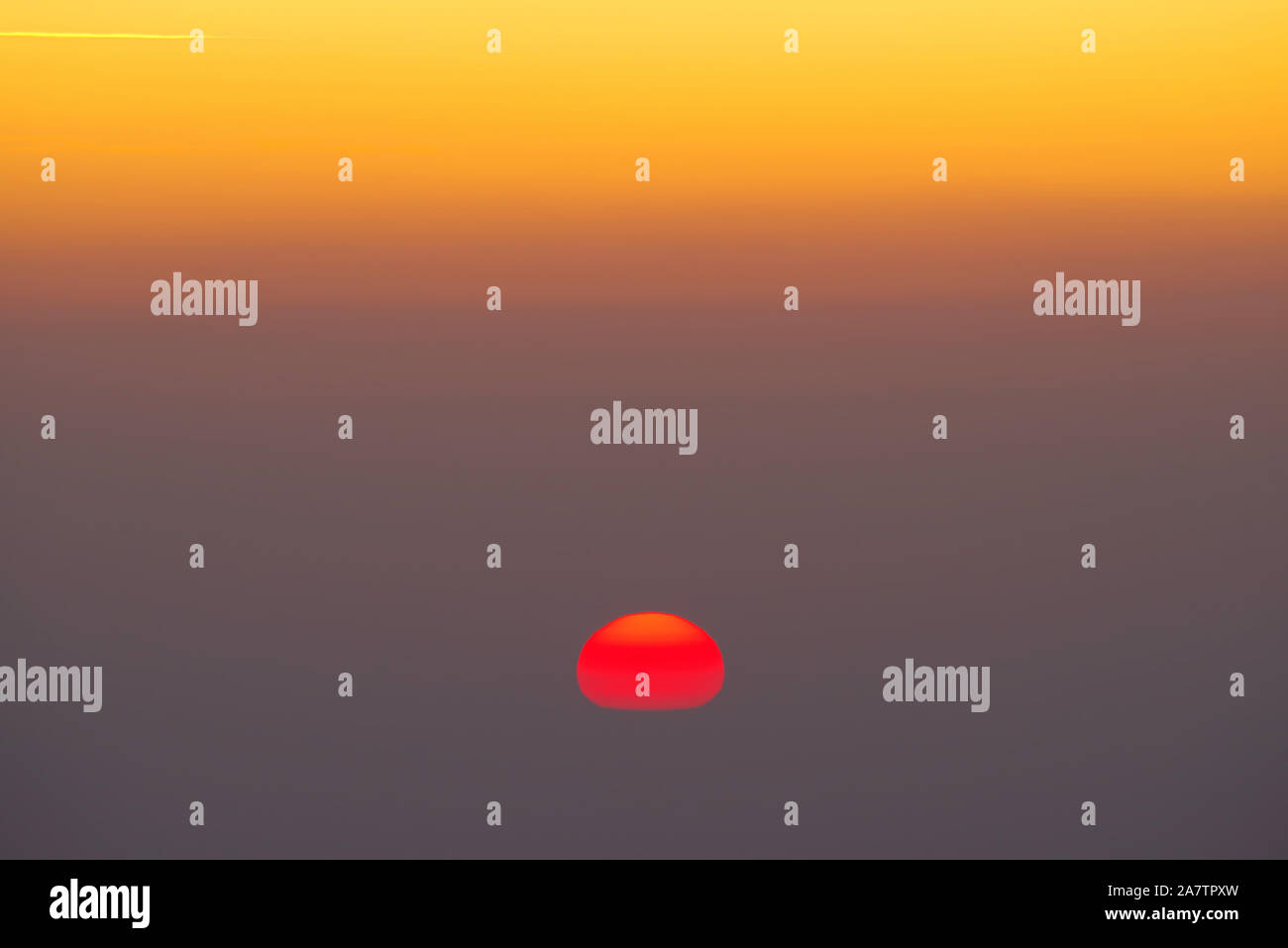 Red sun appear at the horizon, sunrise image Stock Photo - Alamy
