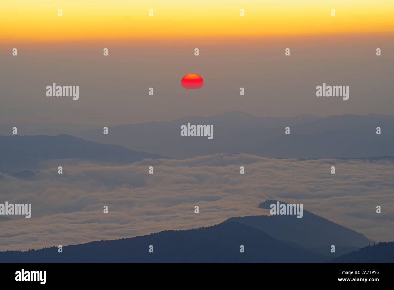 Sunrise scene from mountain top, red sun at horizon Stock Photo - Alamy