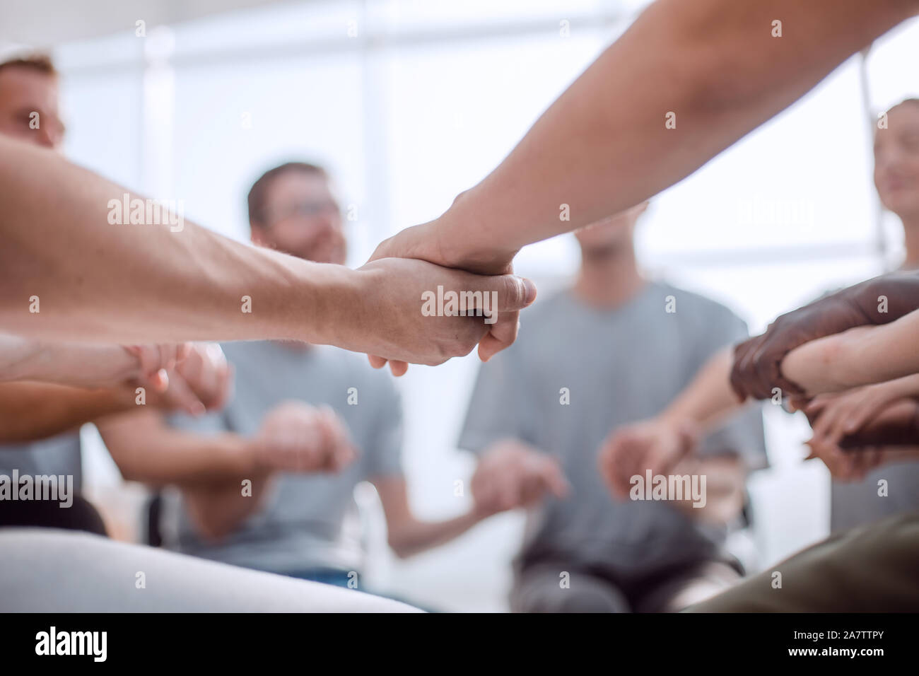 background image is a group of people holding each other's hands Stock ...