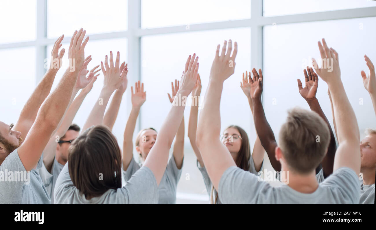 group of young people performing tasks in the classroom teambuilding ...