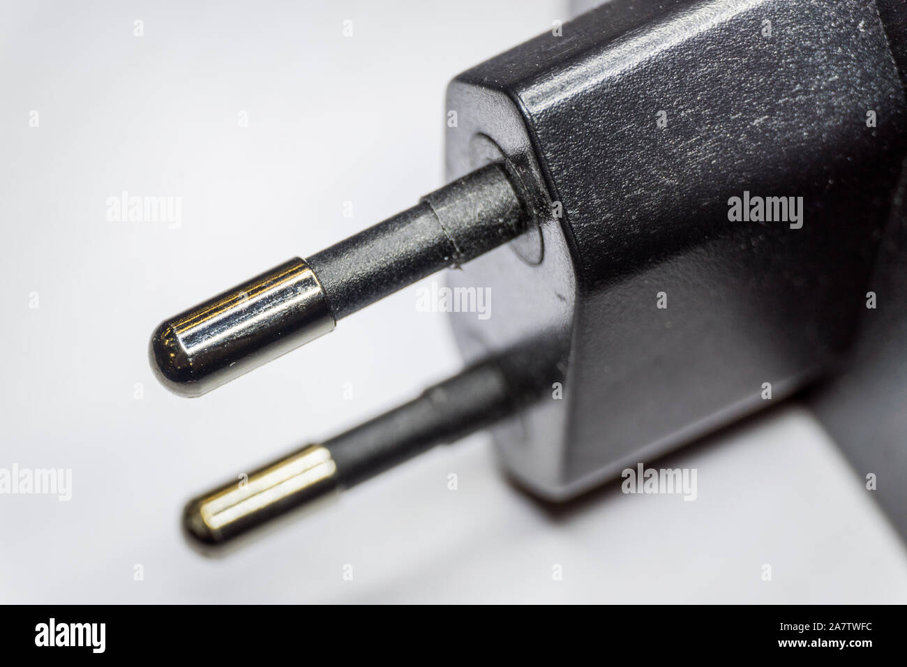 Close-up of black two-pole round-pin 230V AC power supply europlug with ...